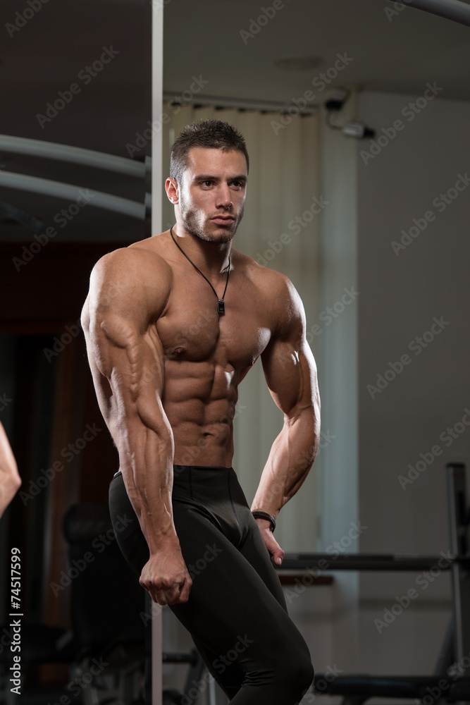 Young Man Performing Side Triceps Pose Stock Photo | Adobe Stock