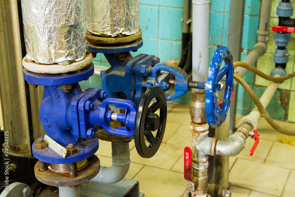 Pipes and faucet valves of heating system in a boiler room Stock Photo ...