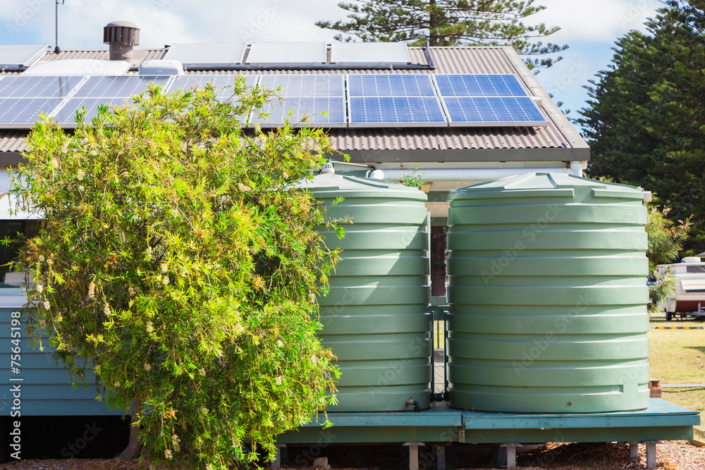 Water tank and solar panels Stock Photo | Adobe Stock