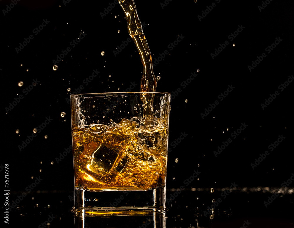 Splashing whiskey Stock Photo | Adobe Stock