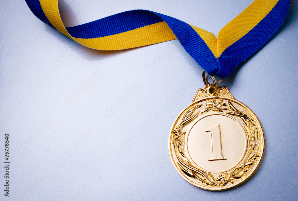 Gold medal on a blue background Stock Photo | Adobe Stock