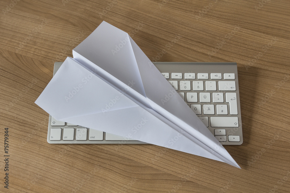 Paper Plane on an office desk Stock Photo | Adobe Stock