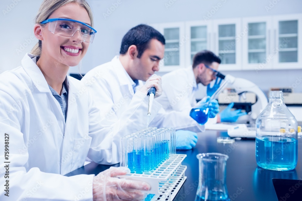 Science student using pipette in the lab to fill test tubes Stock Photo ...