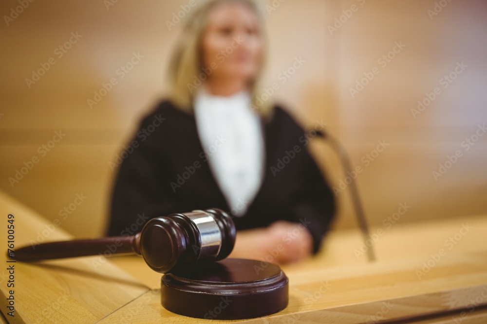 Serious judge with a gavel wearing robes Stock Photo | Adobe Stock
