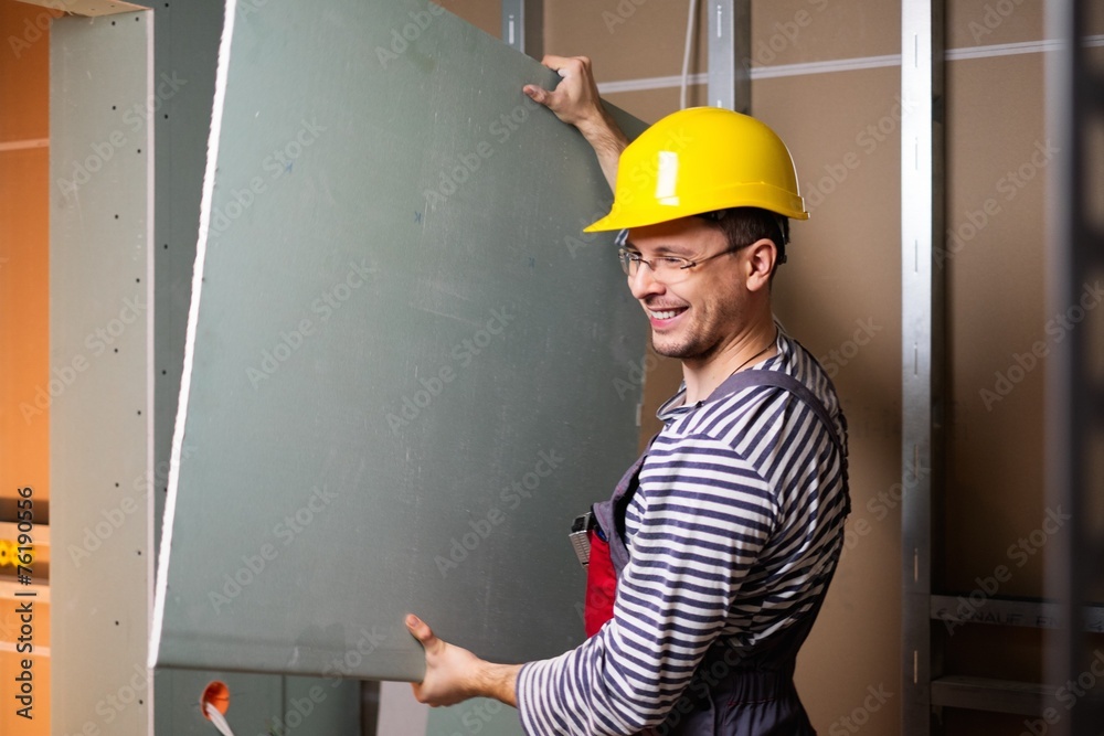 Builder with plasterboard in new building interior Stock Photo | Adobe ...