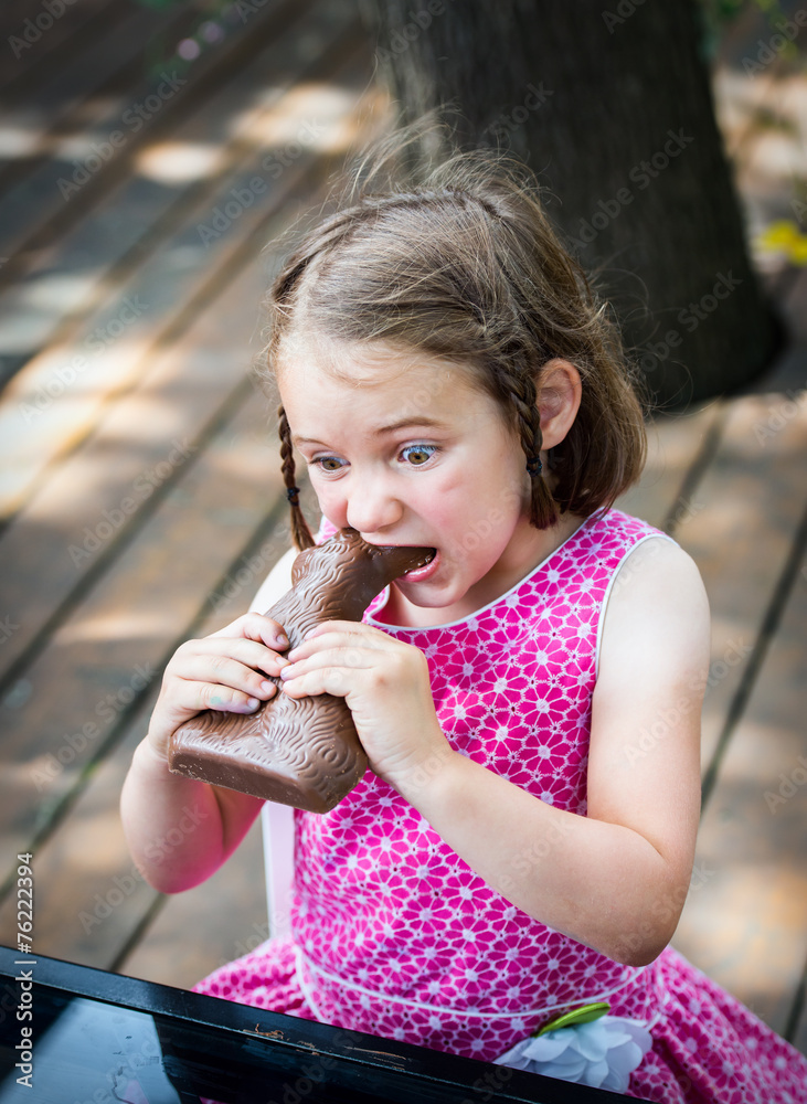 Little Girl Biting Into a Chocolate Bunny Stock Photo | Adobe Stock