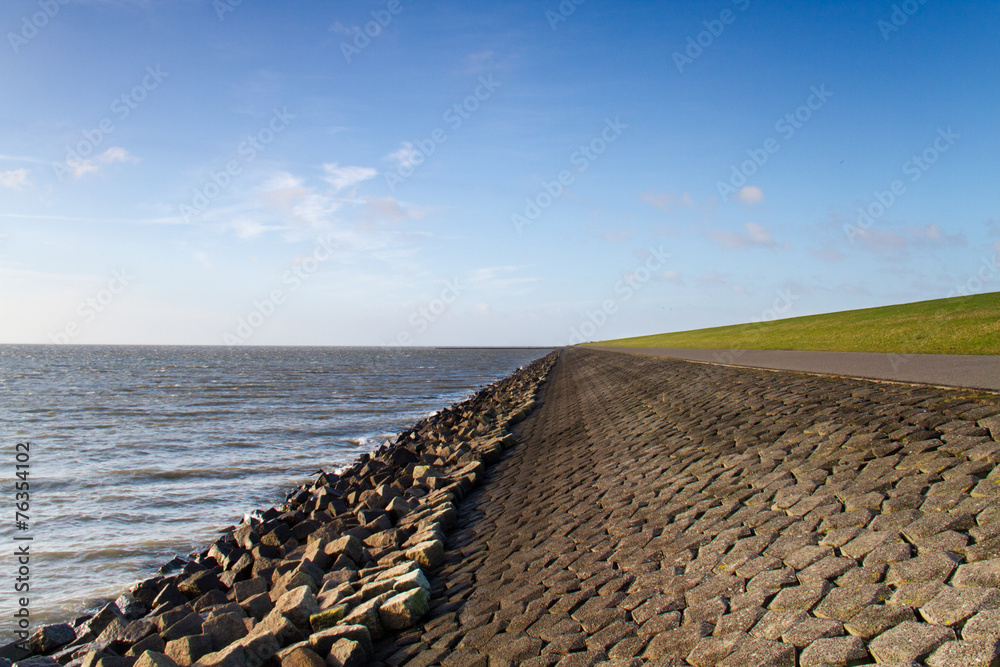 Solid dike rocks, boulders and grass Stock Photo | Adobe Stock