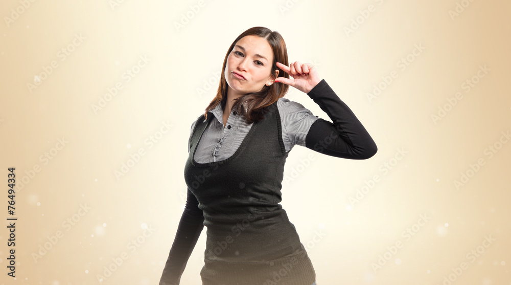 Young girl doing a tiny sign over white background Stock Photo | Adobe ...
