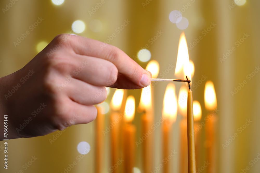 Hand lighting candle Stock Photo | Adobe Stock