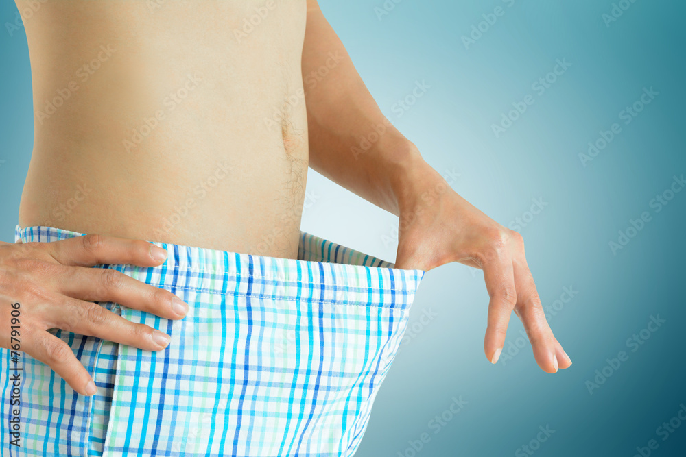 Young man looking inside his boxer shorts Stock Photo | Adobe Stock