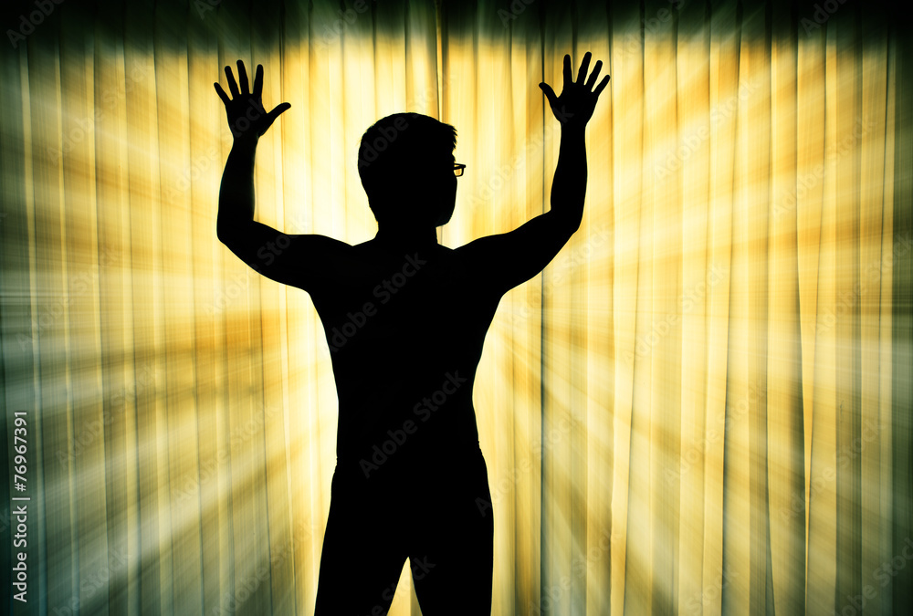 Silhouette of man surrendering with two hands raised in air Stock Photo ...
