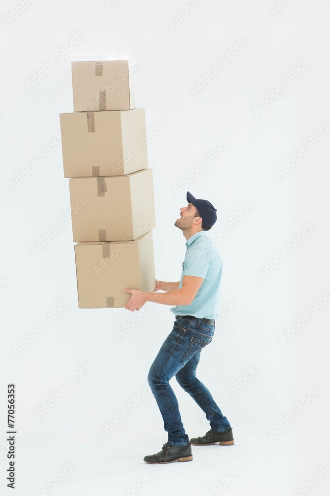 Shocked delivery man carrying stack of boxes Stock Photo | Adobe Stock