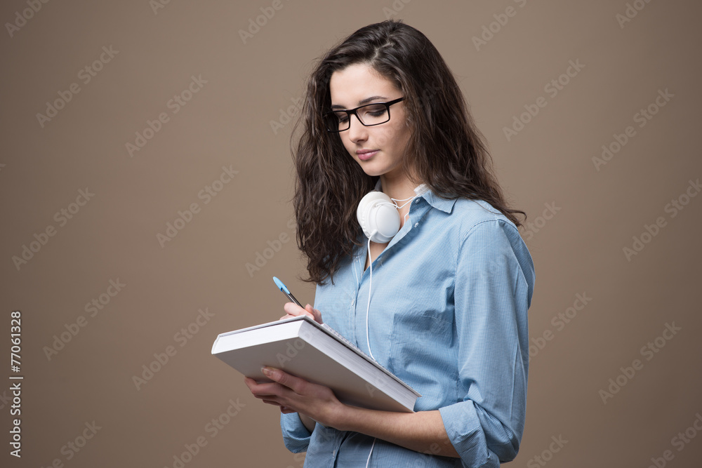 Cute student girl taking notes Stock Photo | Adobe Stock