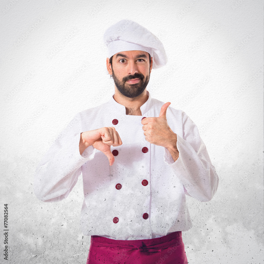 Chef making a good-bad sign over white background Stock Photo | Adobe Stock