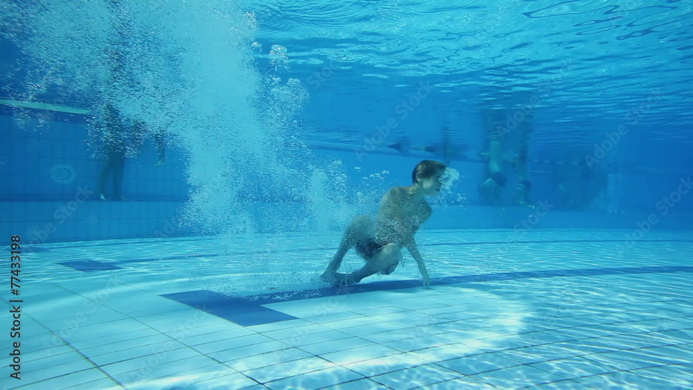 Boy jumps into pool to the bottom Stock Video | Adobe Stock