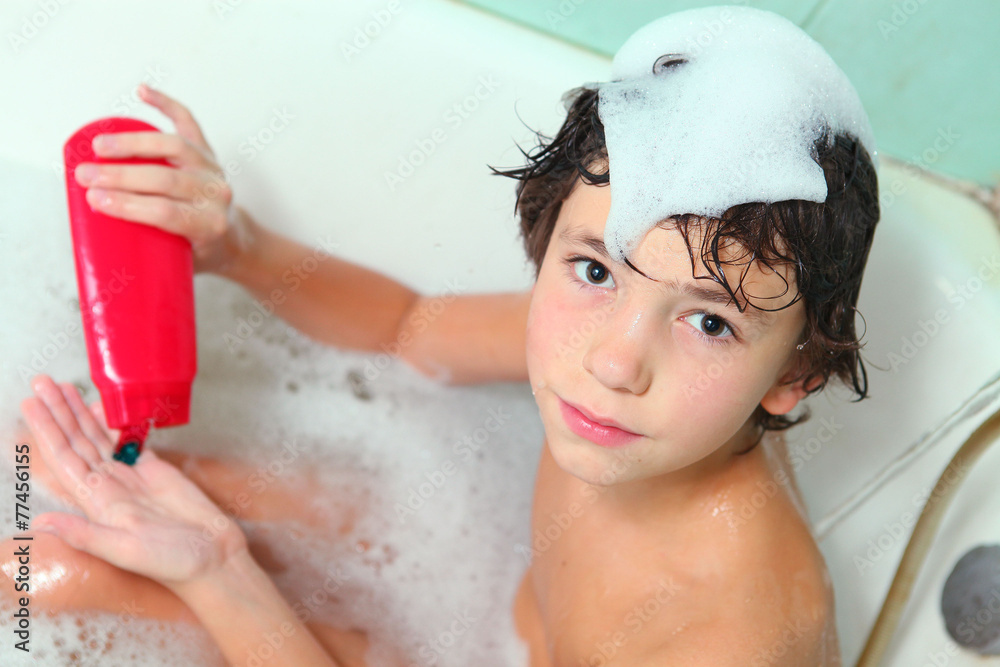handsome preteen boy with shampoo take soap bath and wash his he Stock ...