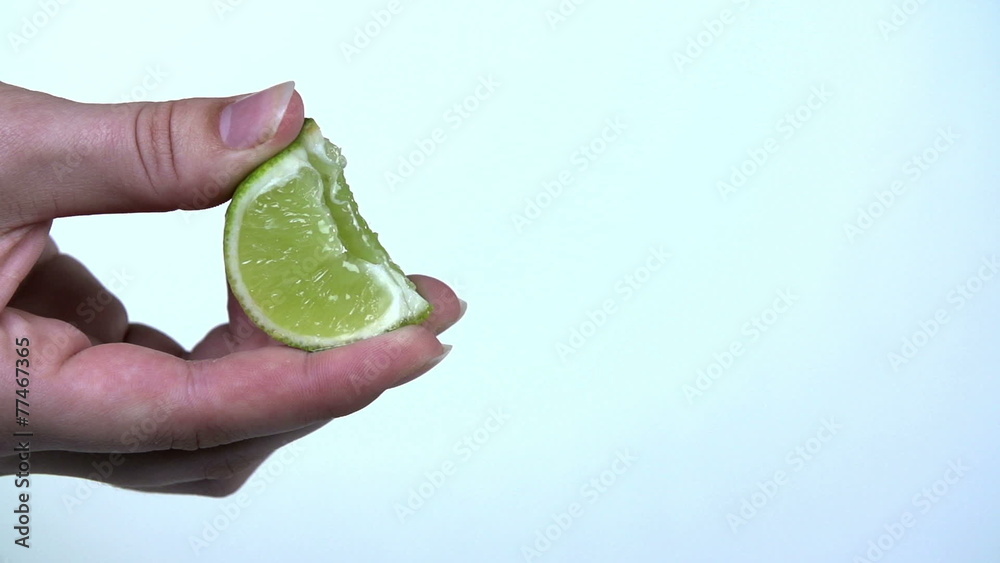 Squeezing a piece of lime with squirting juices Stock Video | Adobe Stock