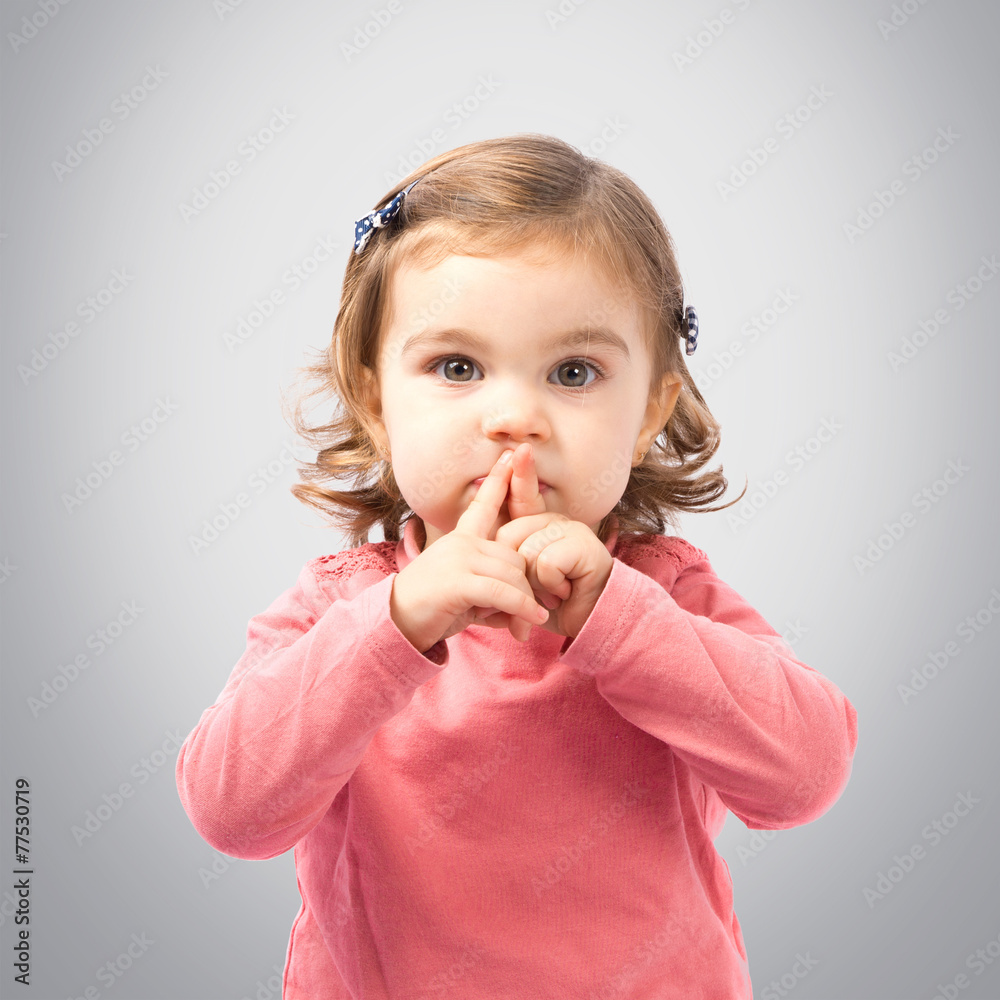 Cute girl doing silence gesture over white background Stock Photo ...