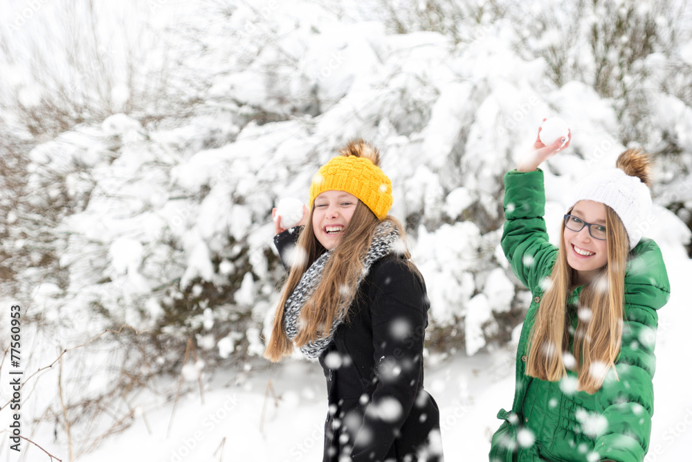 Two Tween Girls throwing snowballs Stock Photo | Adobe Stock