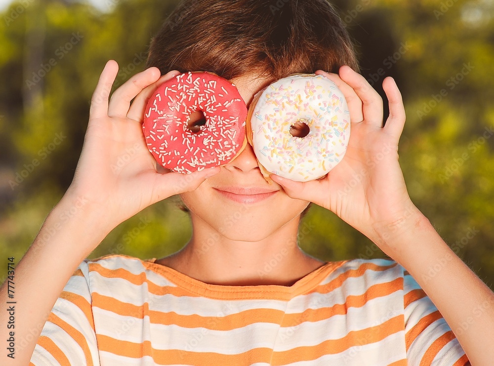 Kid boy with donuts Stock Photo | Adobe Stock