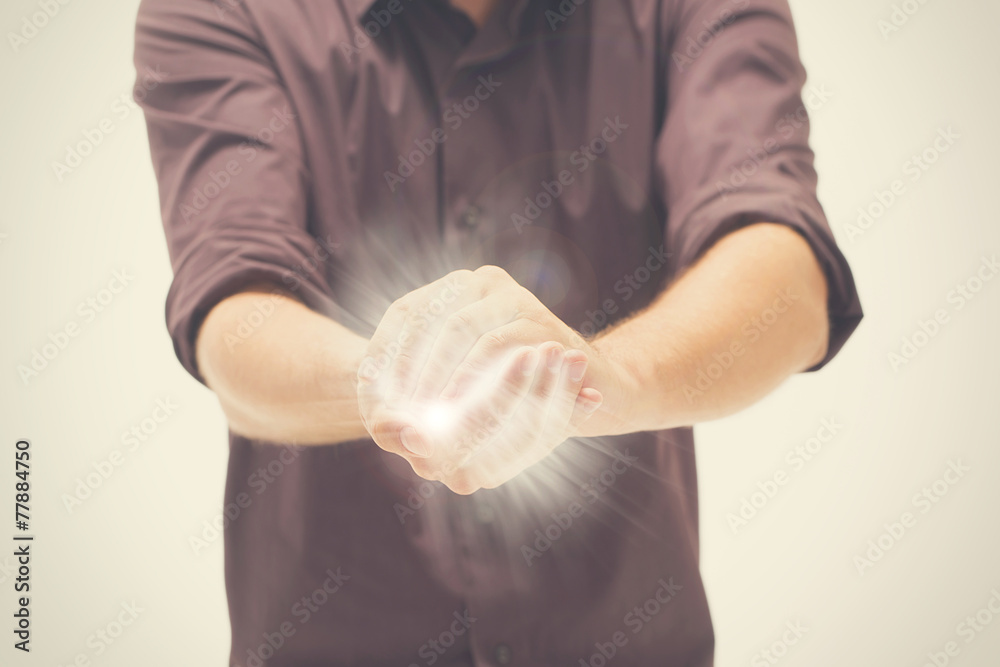 Man trying to hold the light between hands Stock Photo | Adobe Stock