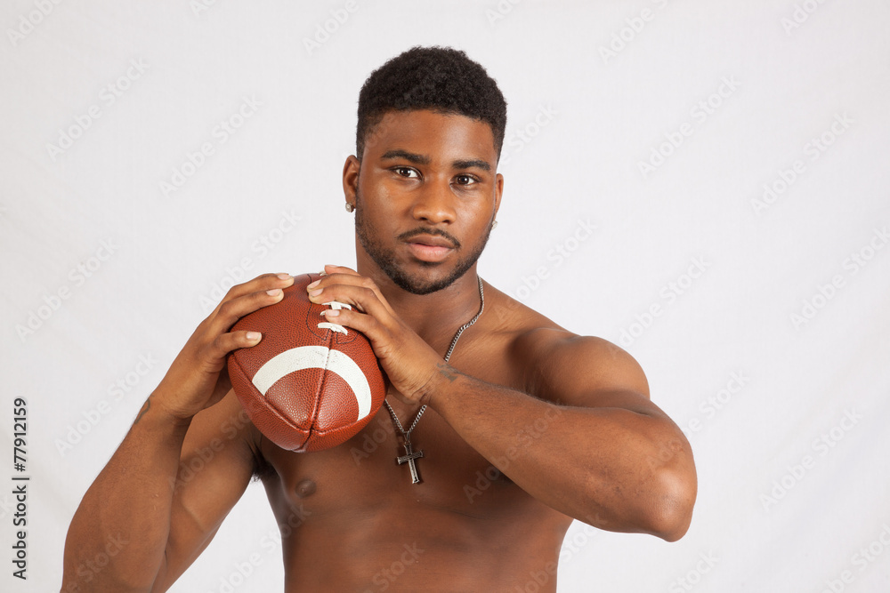 Shirtless black man throwing a football Stock Photo | Adobe Stock