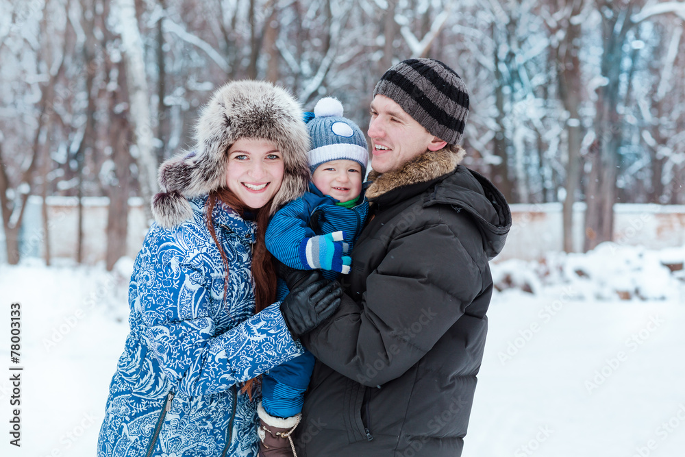 Happy family playing on snow Stock Photo | Adobe Stock