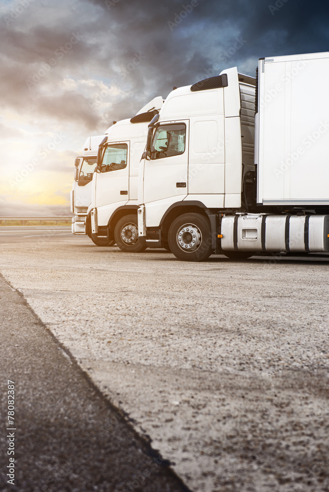 Three white trucks in a row Stock Photo | Adobe Stock