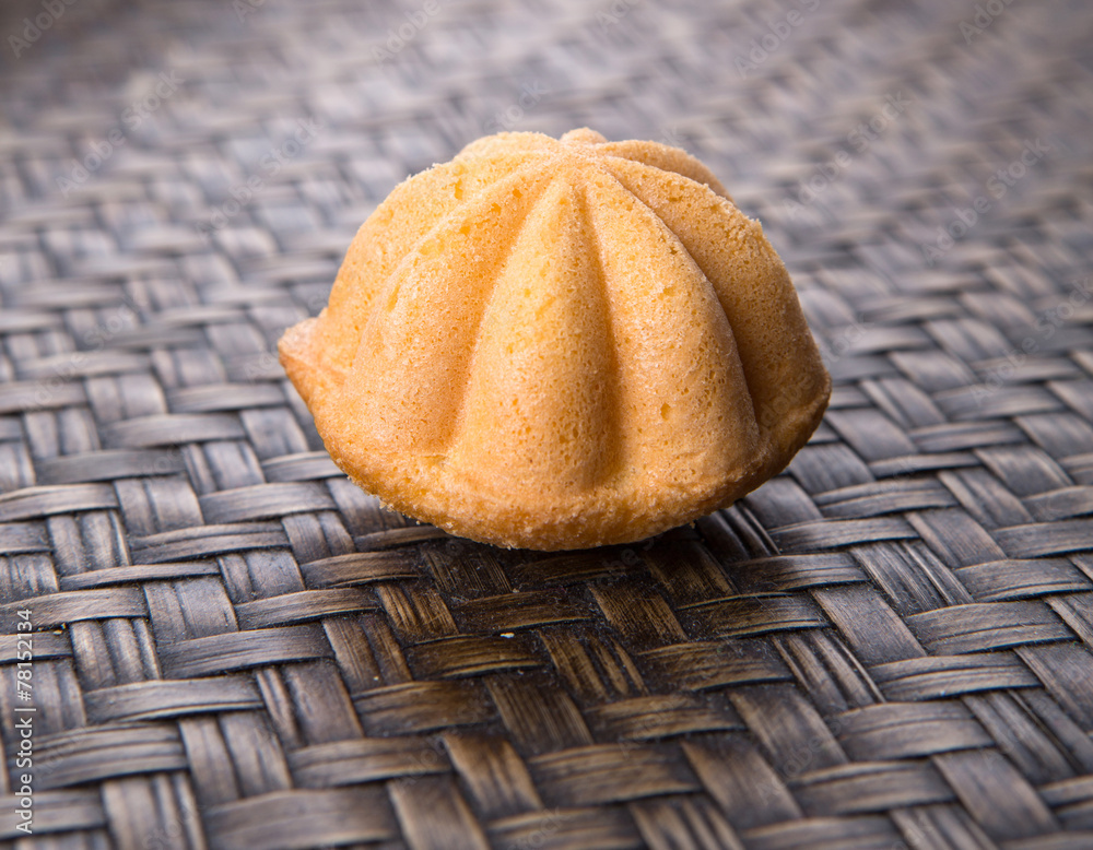 Kuih bahulu, a Malay sweet egg sponge cake on wicker mat. Stock Photo ...