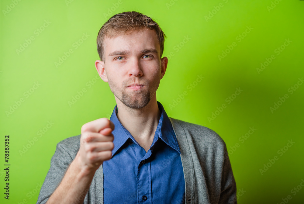 Closeup portrait of young man giving thumb, finger fig gesture that you ...