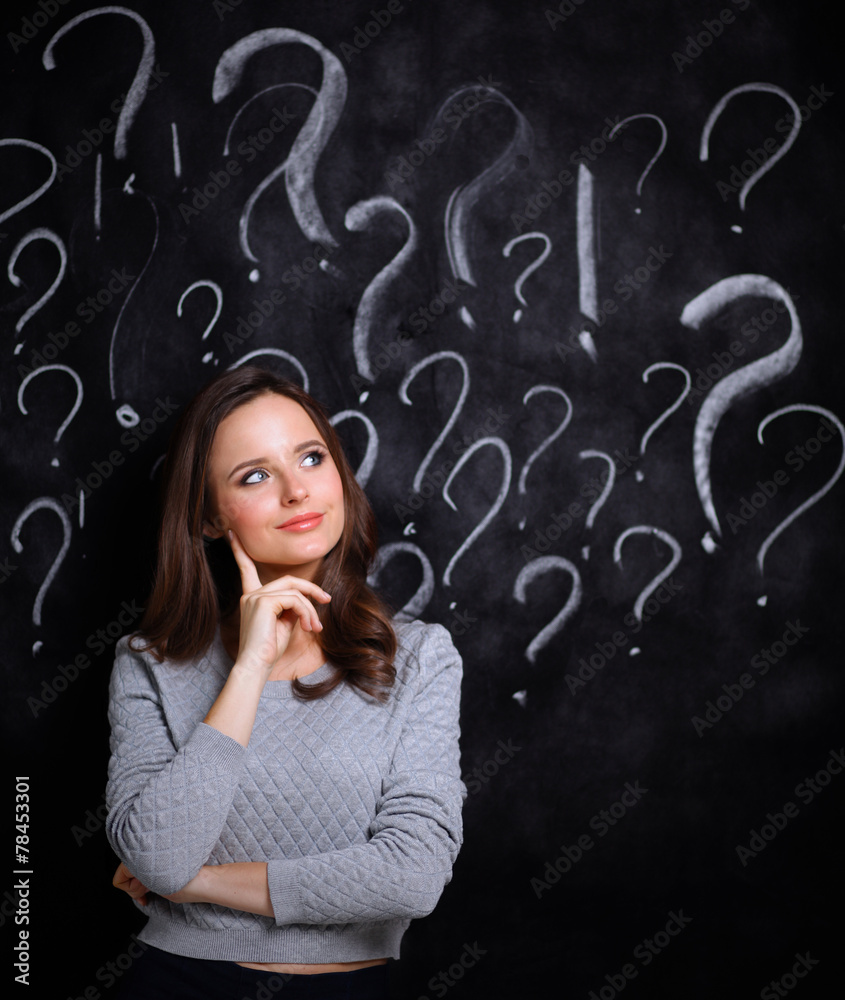 Young girl with question mark on a gray background Stock Photo | Adobe ...
