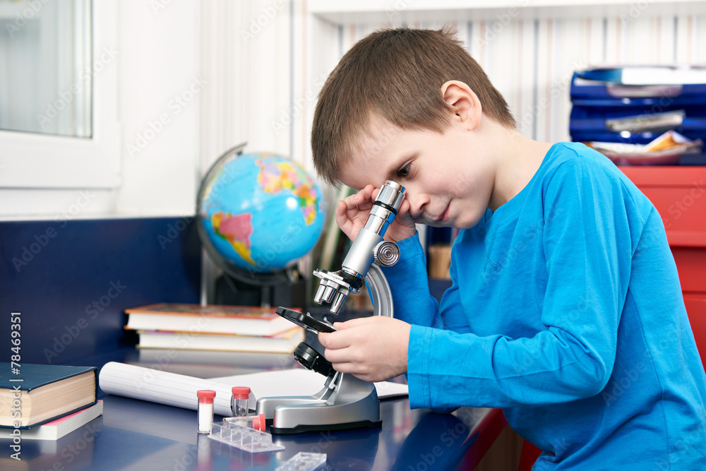 Boy looking in microscope Stock Photo | Adobe Stock