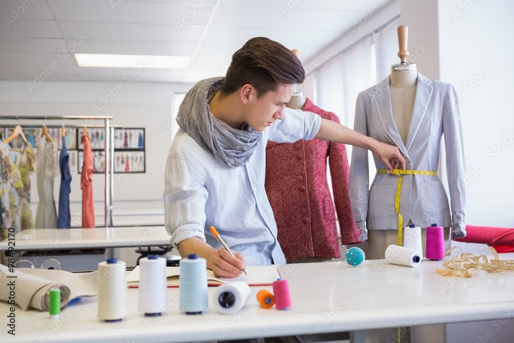Fashion student taking notes and measuring Stock Photo | Adobe Stock
