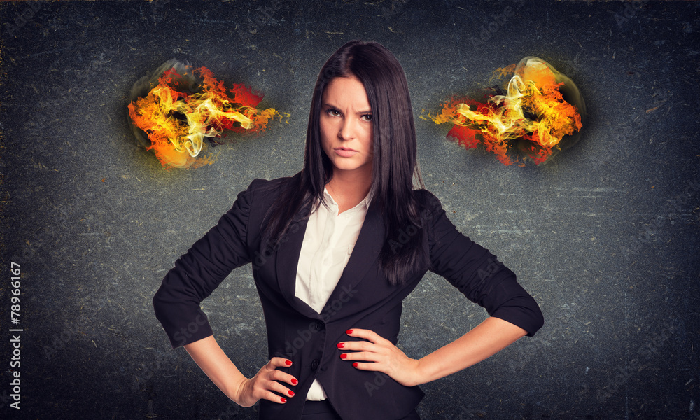 Angry woman standing with arms akimbo, fire from ears. Concrete Stock ...