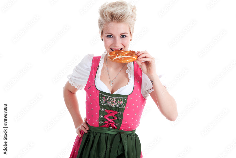Frau im Dirndl isst Breze und lächelt Stock-Foto | Adobe Stock