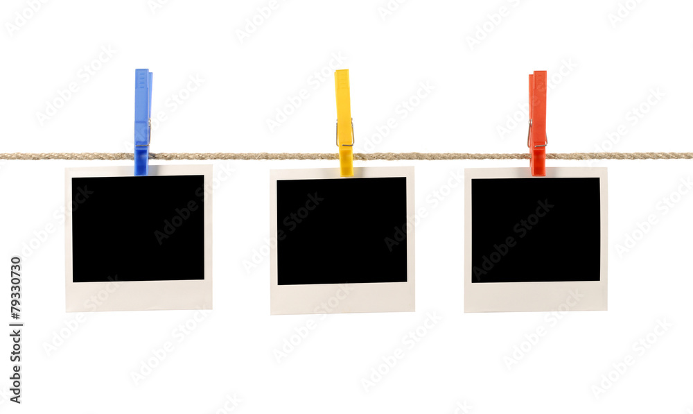 Three blank polaroid style instant photo frame prints on a rope string ...