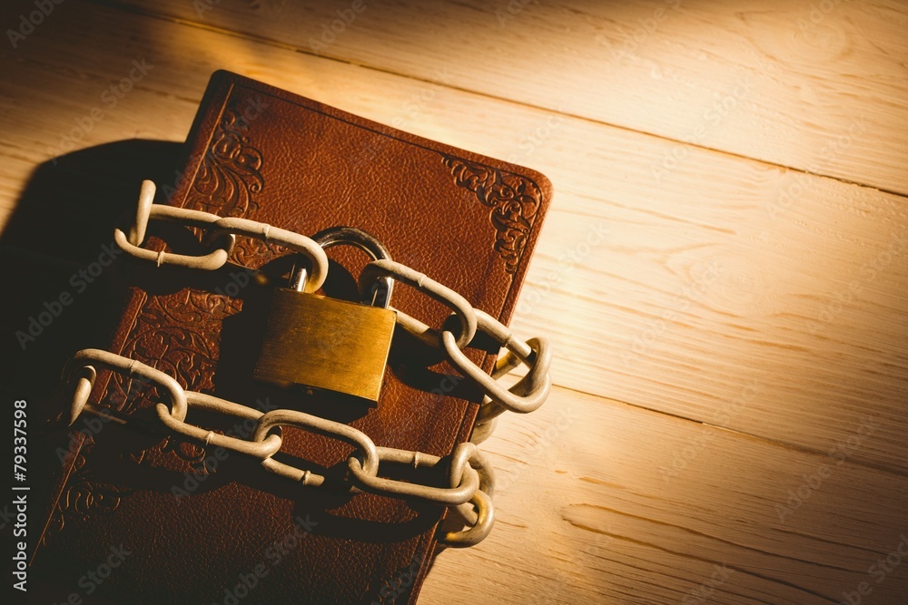 Open bible chained with lock Stock-Foto | Adobe Stock