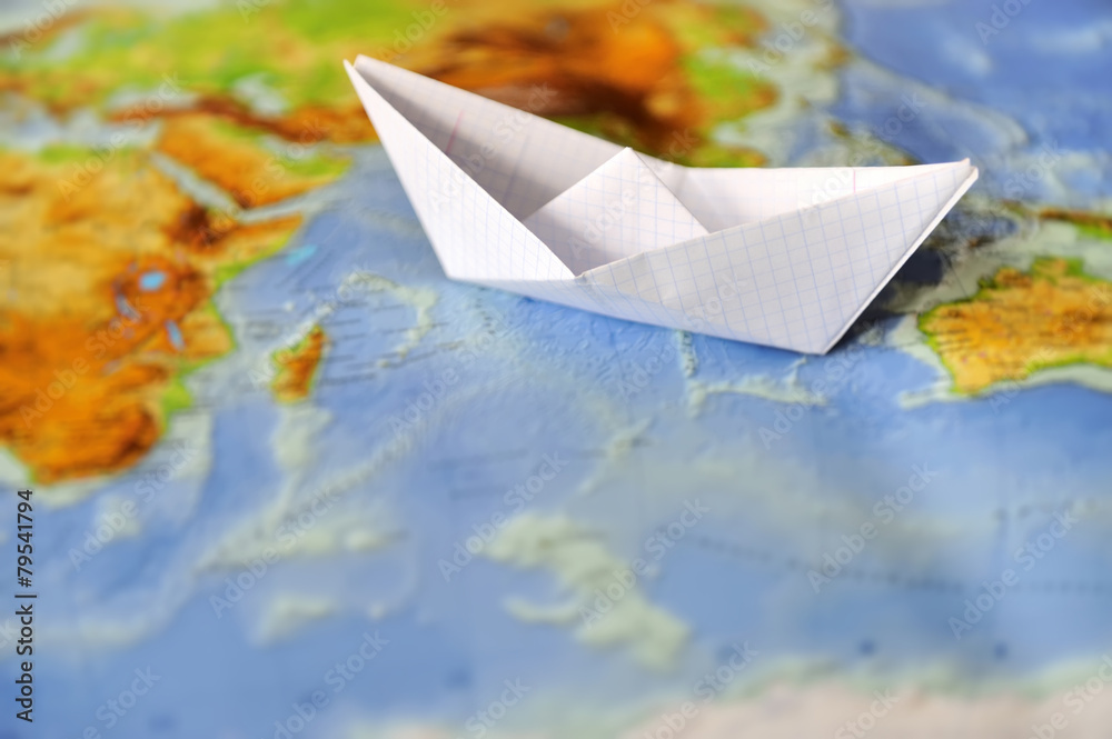 Paper boat on a background map of the world Stock Photo | Adobe Stock