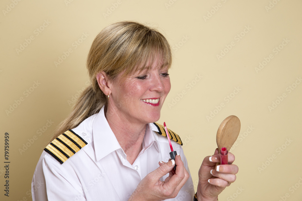 Female airline pilot applying lipstick makeup Stock Photo | Adobe Stock