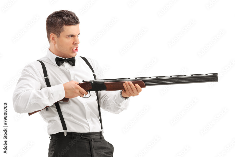 Angry young man shooting with a shotgun Stock Photo | Adobe Stock