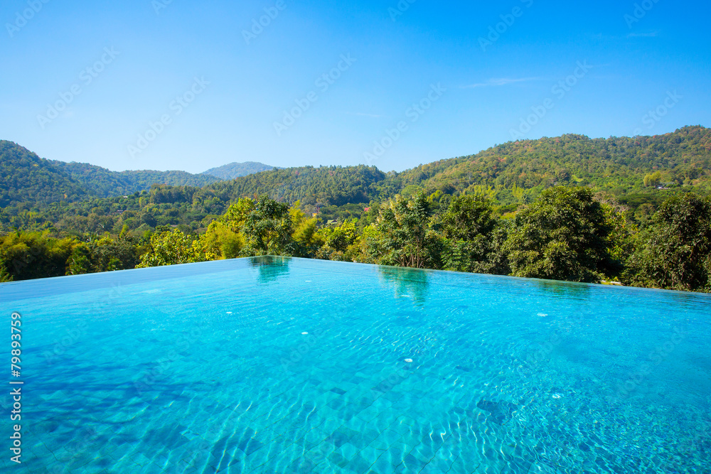 Beautiful blue pool overlooking mountain landscape Stock-Foto | Adobe Stock