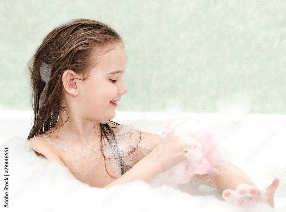 Smiling little girl washing in bath Stock Photo | Adobe Stock