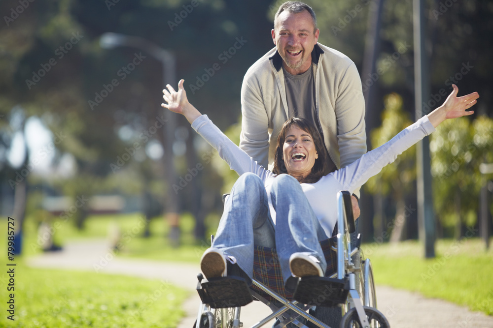 Man pushing enthusiastic woman in wheelchair Stock-Foto | Adobe Stock Man pushing enthusiastic woman in wheelchair Stock-Foto | Adobe Stock