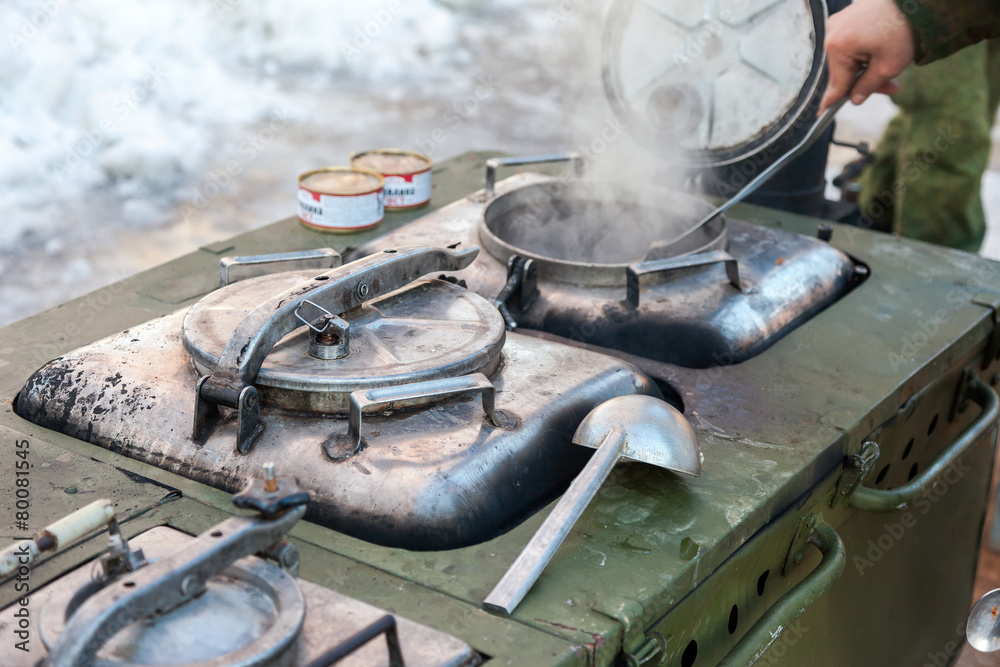 Cooking on a military field kitchen in field conditions Stock Photo ...