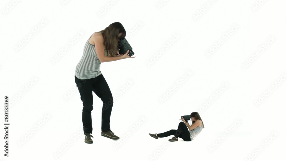 Woman films a smaller version of herself, who in turn lays back to film ...