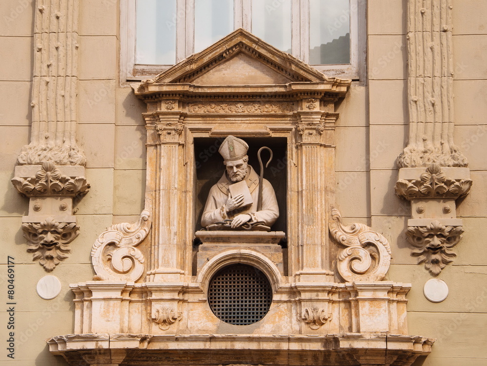 Sculpture of Catholic priest is decorated old building foto de Stock ...