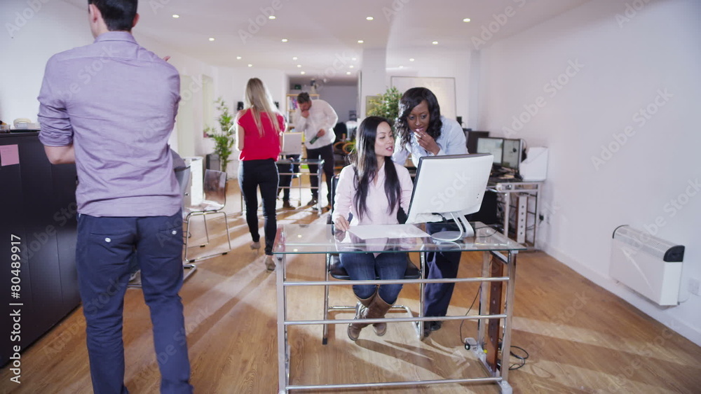 Business people working together in a light and modern open plan office ...