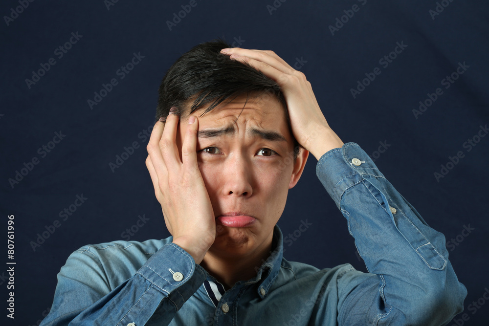 Disappointed young Asian man crying and looking sideways Stock Photo ...