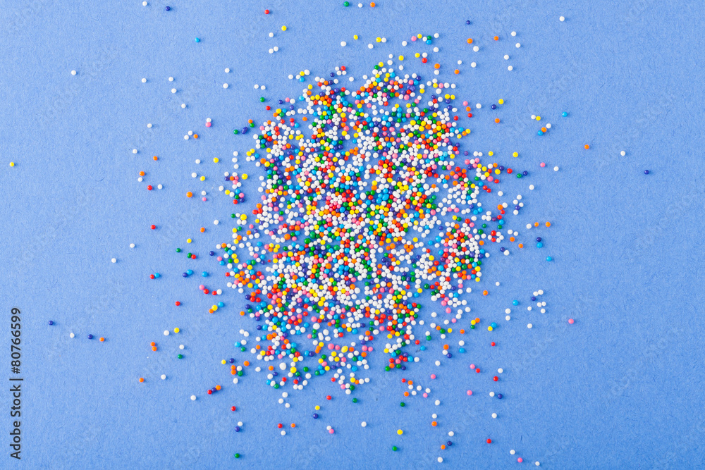 Colorful round sprinkles spilled on blue background, isolated Stock ...