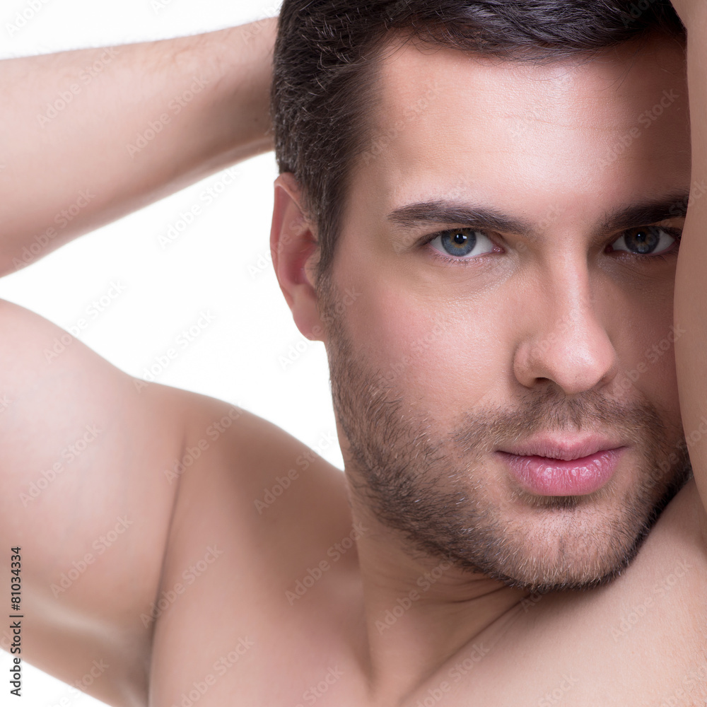 Close-up portrait of happy smiling young man. Photos | Adobe Stock
